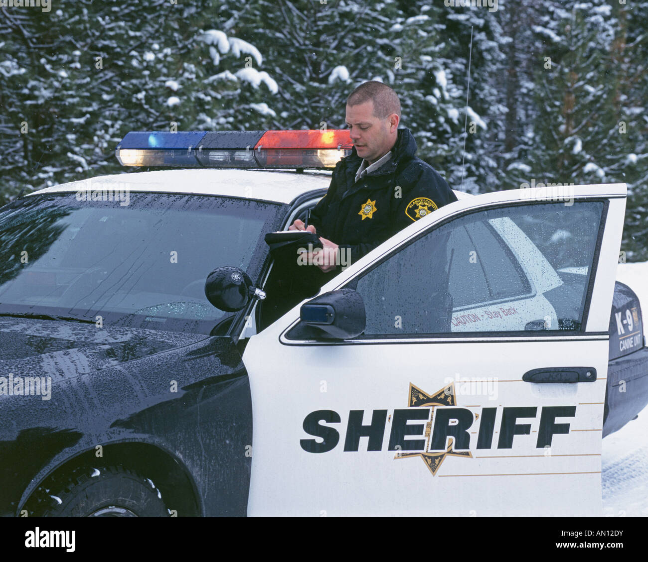 A Sheriffs Department police officer takes part in a highway roadblock ...
