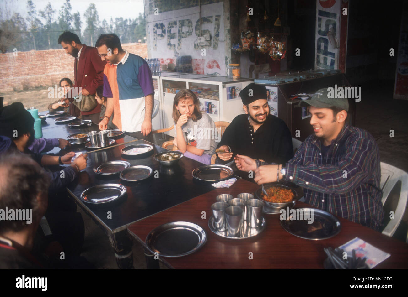 Group of tourists eating food in roadside café in India Stock Photo - Alamy