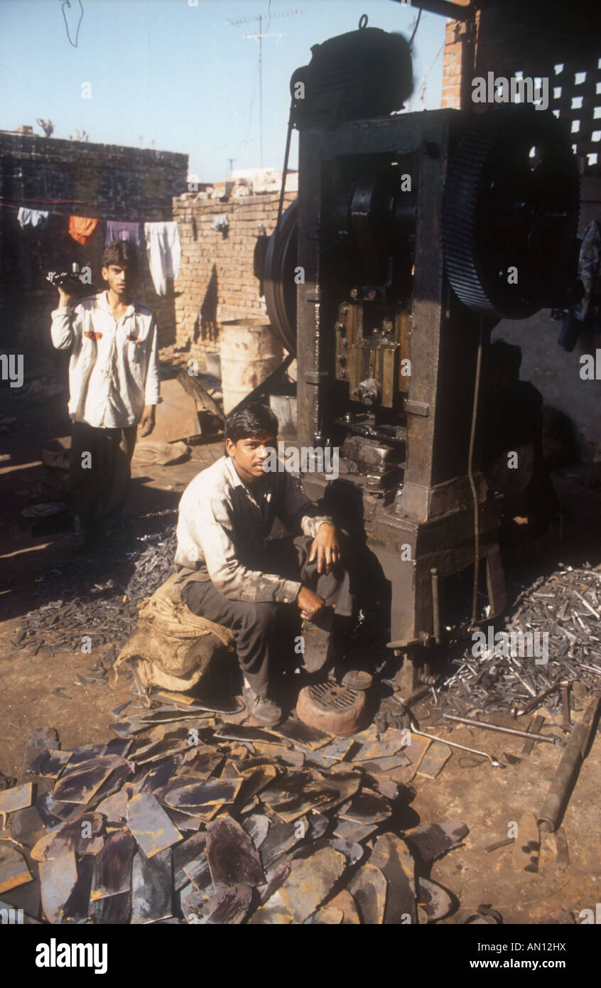 Metal work shop in the Punjab, India, with worker using press Stock ...