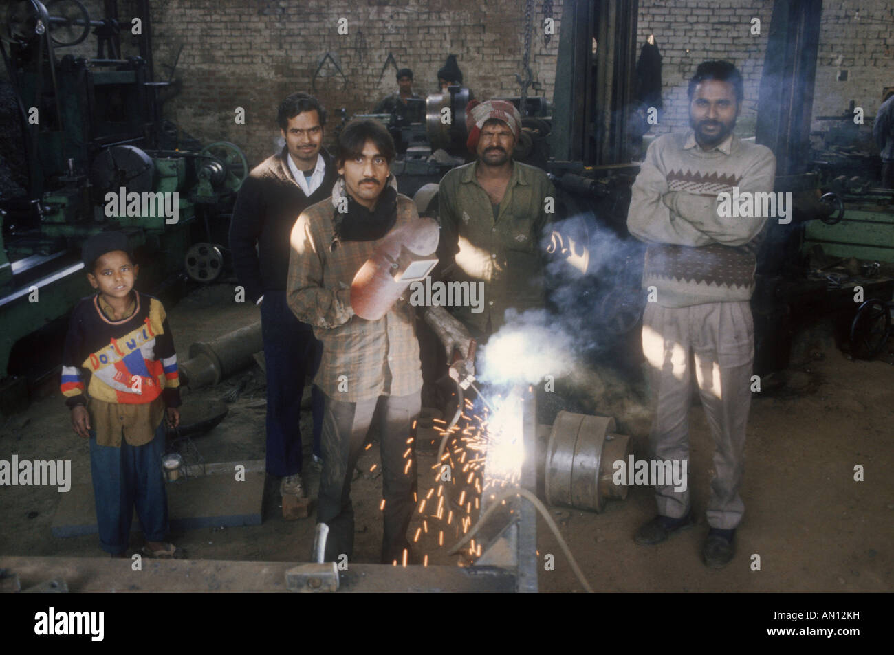 Metal work shop in the Punjab, India, with workers welding Stock Photo ...