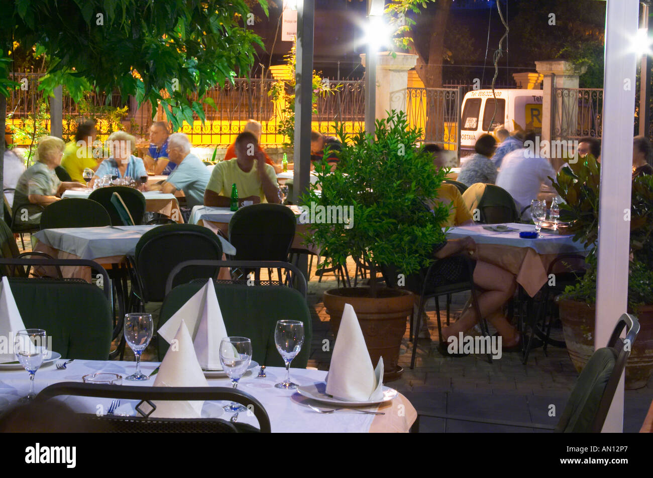 Outside seating terrasse at the restaurant. Guests having dinner ...
