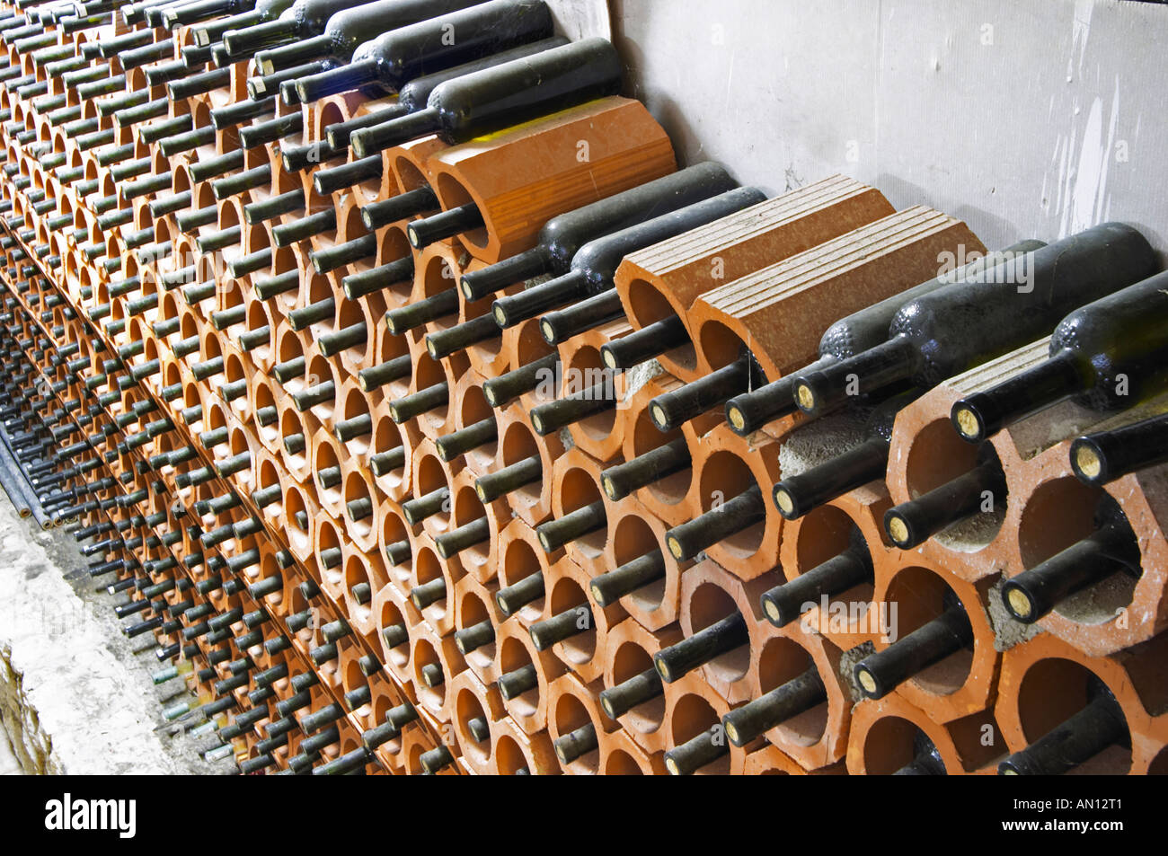 A big stack of bottles stored laying down stacked piled high in ...