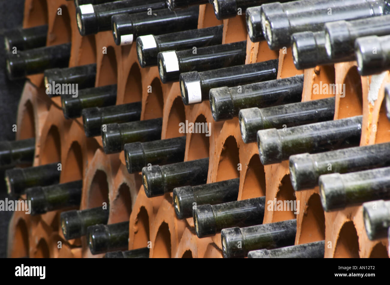 A big stack of bottles stored laying down stacked piled high in ...