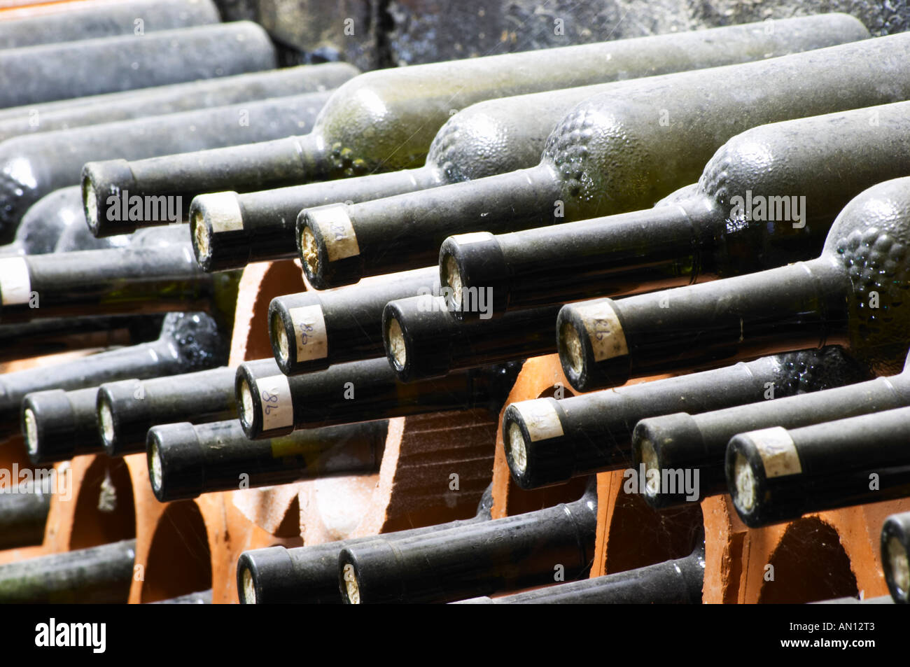 A big stack of bottles stored laying down stacked piled high in ...