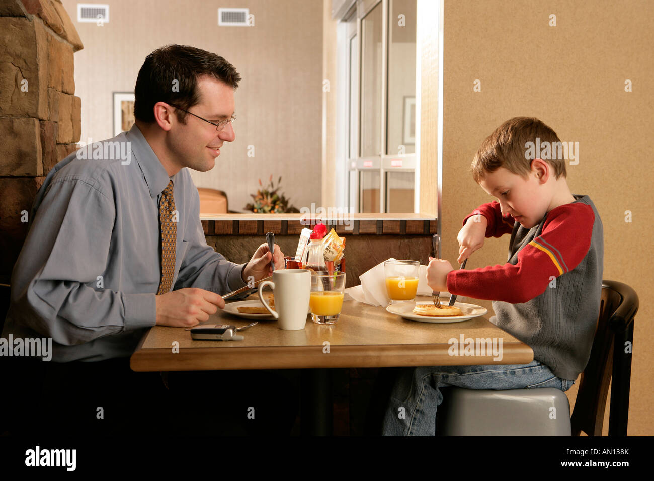 Father and son at eating breakfast Stock Photo - Alamy