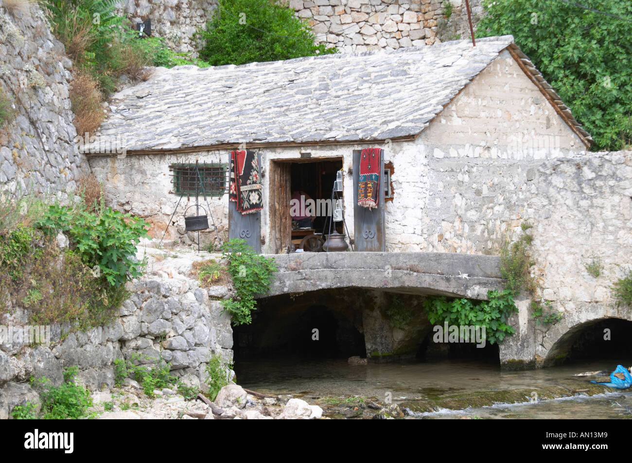 The old Ottoman style water mill building with roof tiled with stone ...