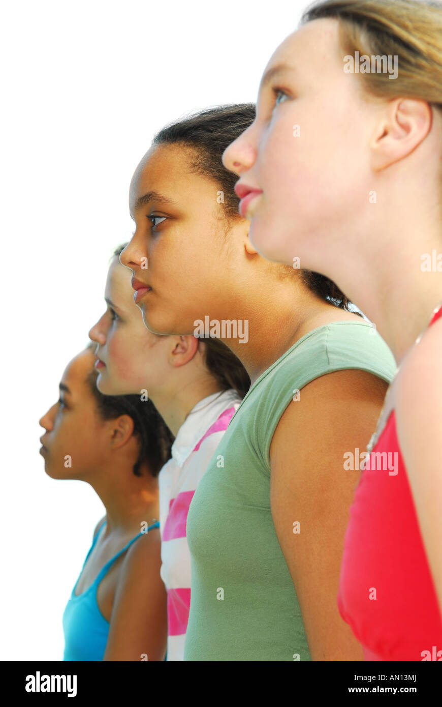 Profile portrait of four teenage girls looking into future with ...