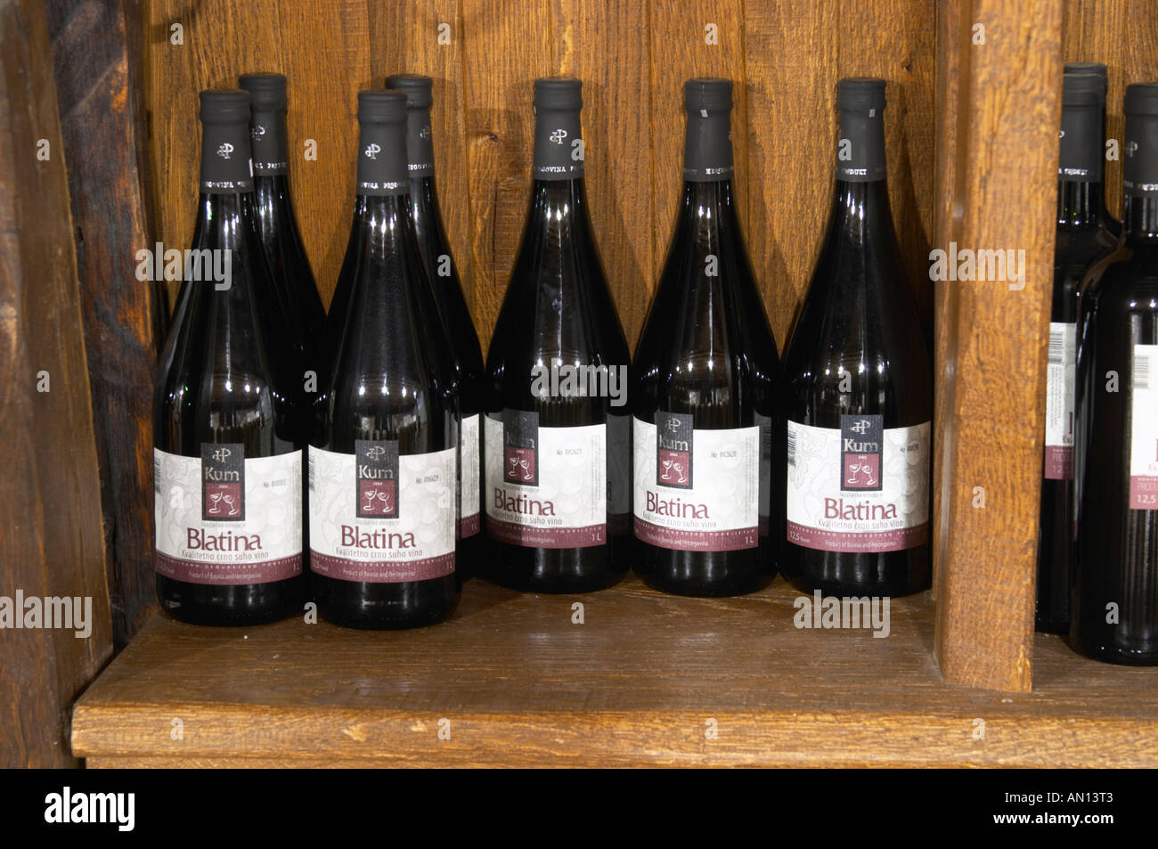 Bottles of Kum Blatina on a shelf in the wine shop. Hercegovina Produkt ...