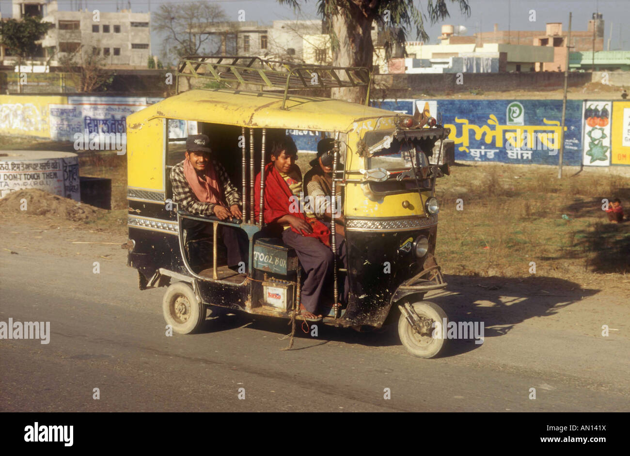 Auto rickshaw driving along street in India Stock Photo - Alamy