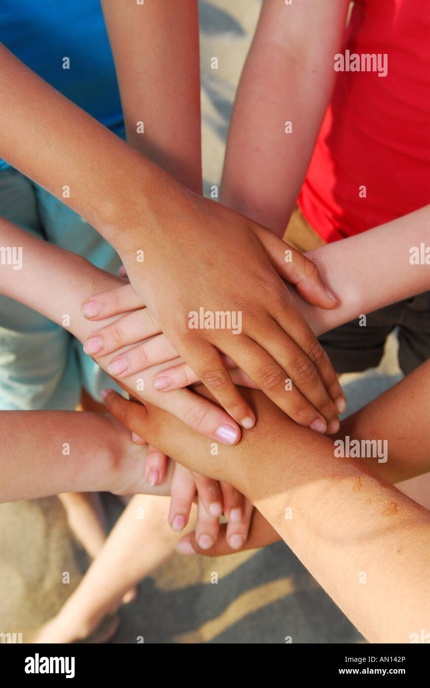 Hands of diverse group of teenagers joined in union Stock Photo - Alamy