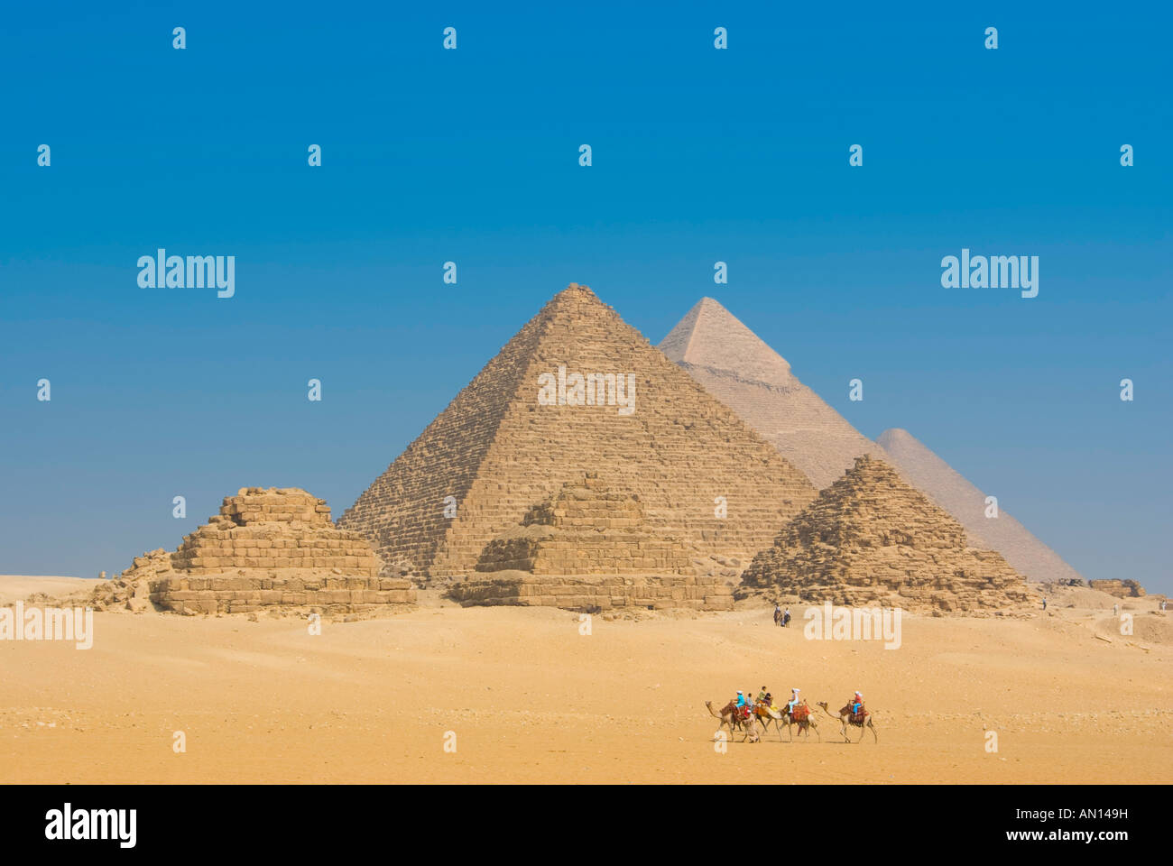 Tourists on camels at Giza pyramids Stock Photo - Alamy