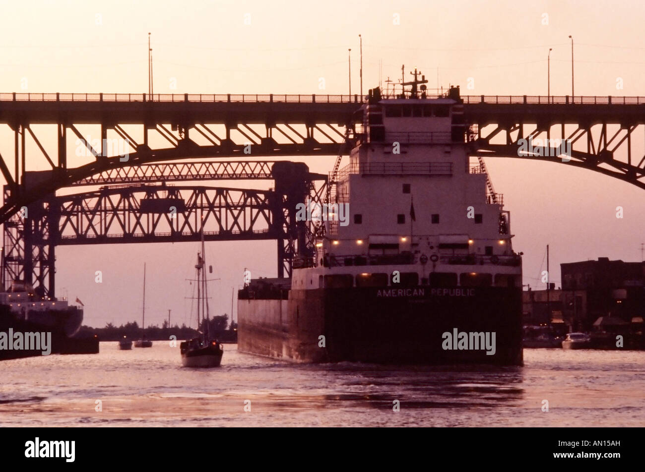 Shipping vessels on the Cuyahoga River at sunset in Cleveland Ohio USA ...