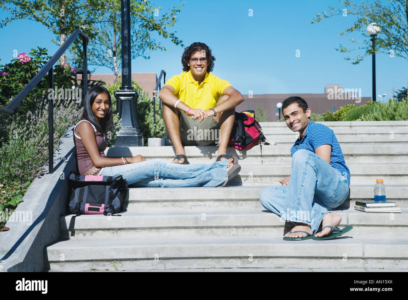 Multi-ethnic college students sitting on steps Stock Photo - Alamy