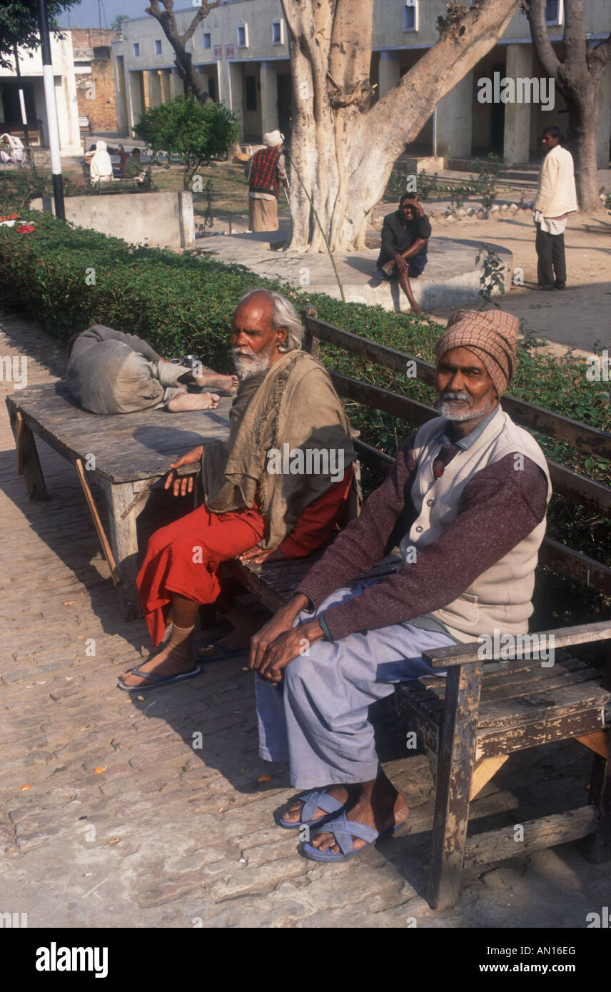 Men with learning disabilities sitting on bench in the grounds of the ...