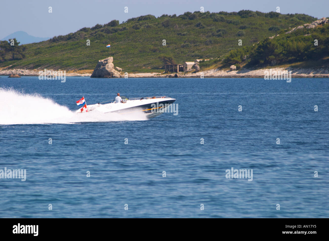 A speedboat speed boat in high speed across the water with white spray ...