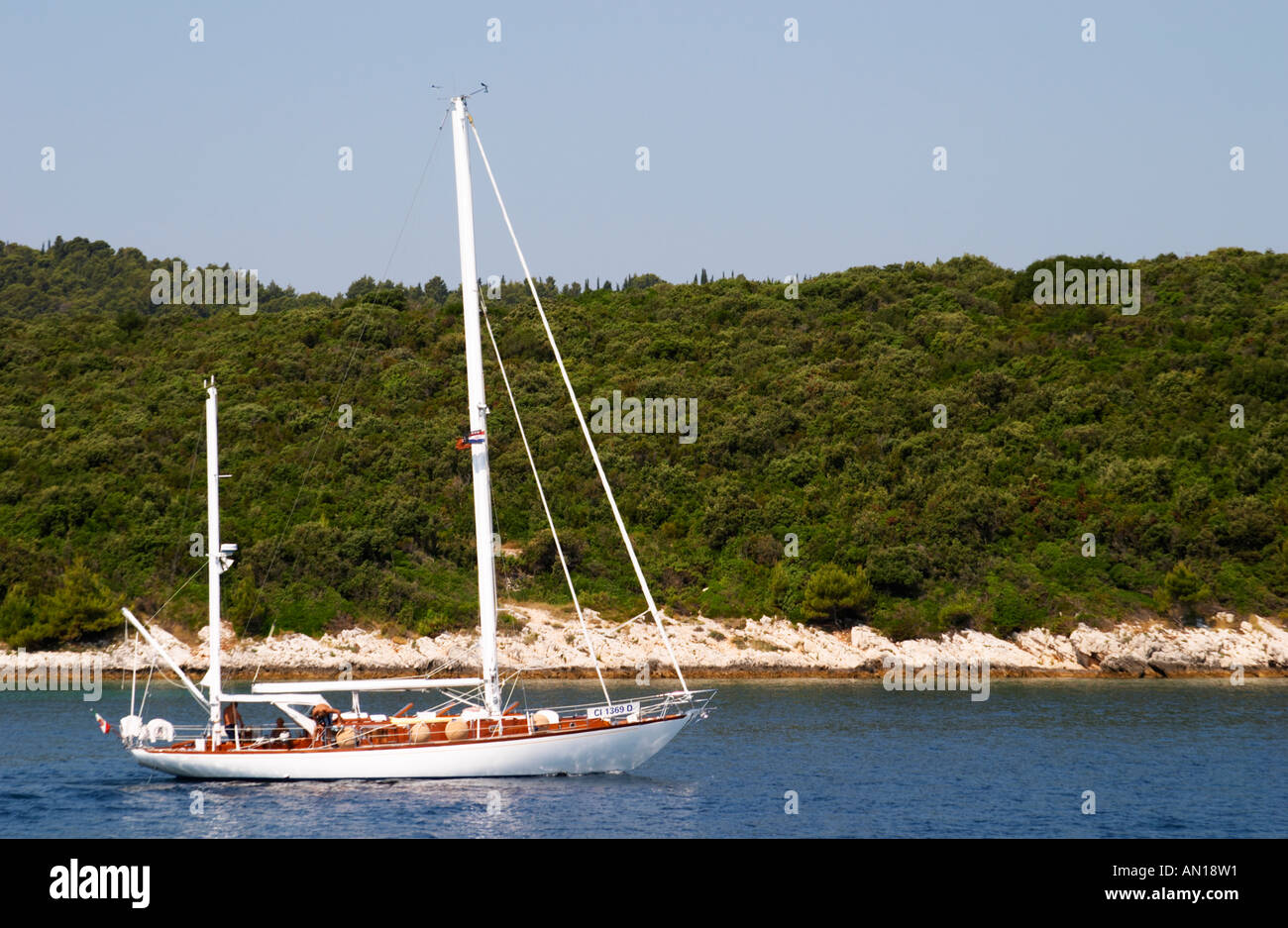 A two mast white sailing boat sailing on the deep blue sea water ...