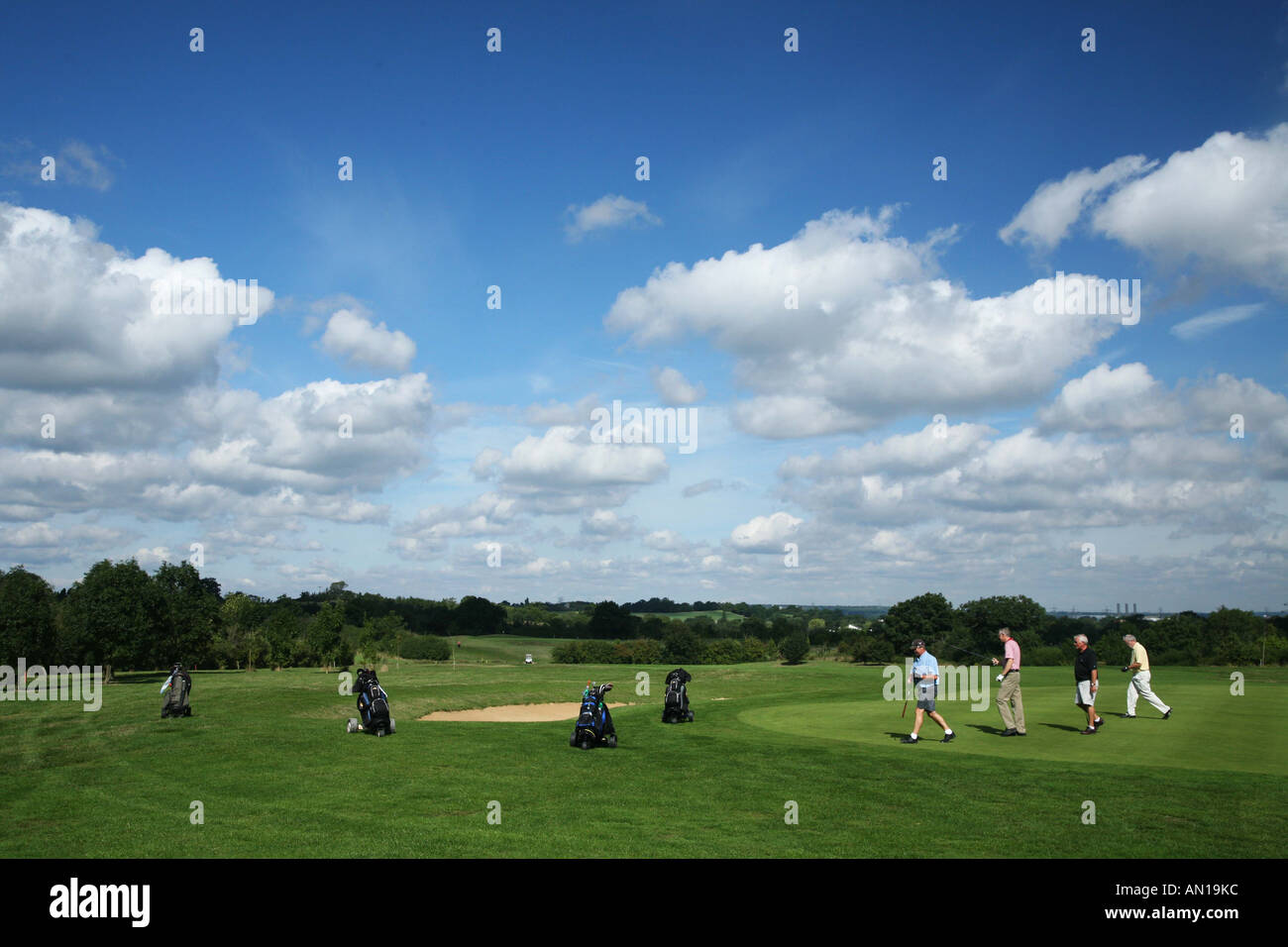 Golfers walk across golf course hi-res stock photography and images - Alamy