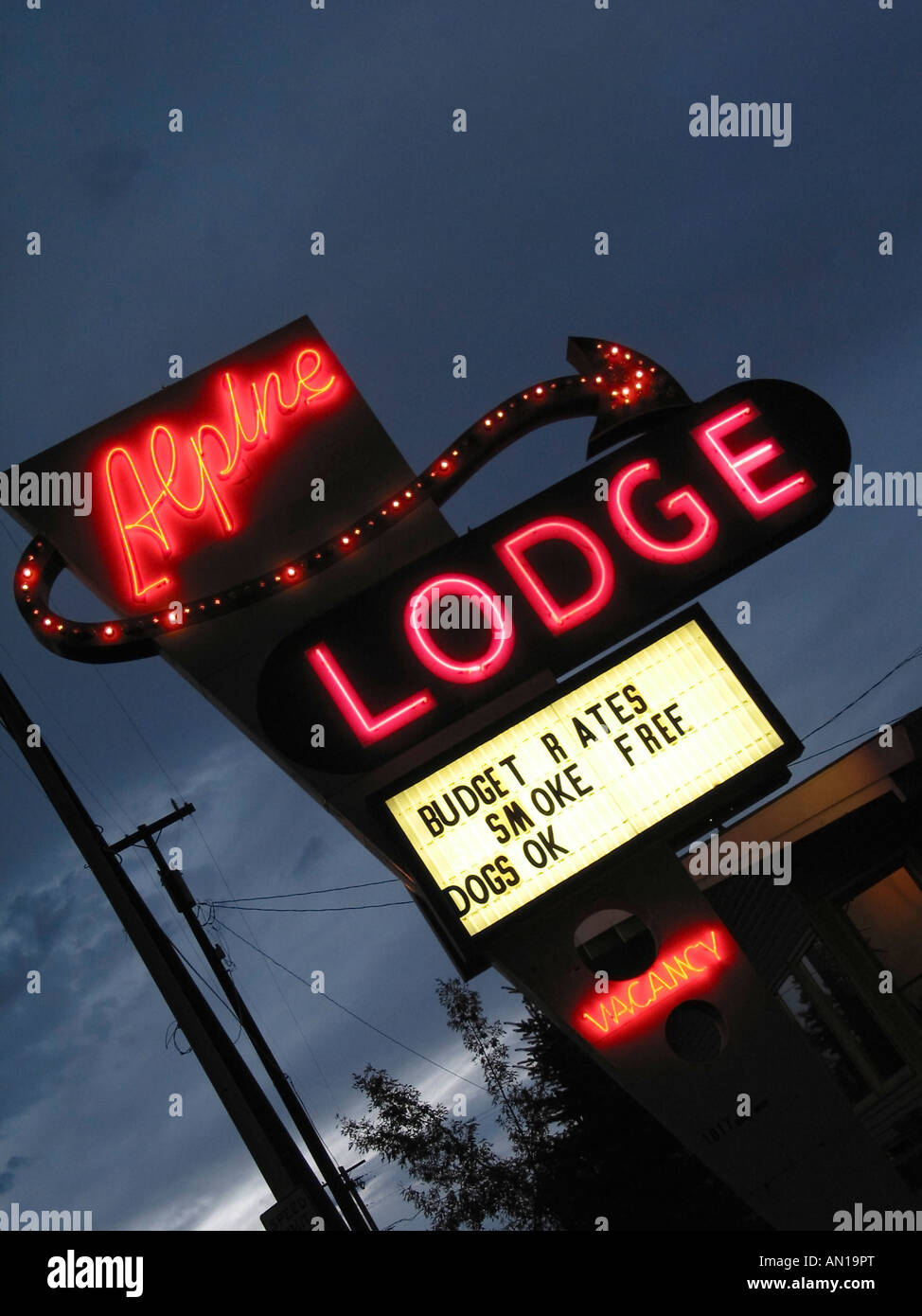 USA, Montana, Bozeman. Alpine Lodge sign lights as night falls Stock ...