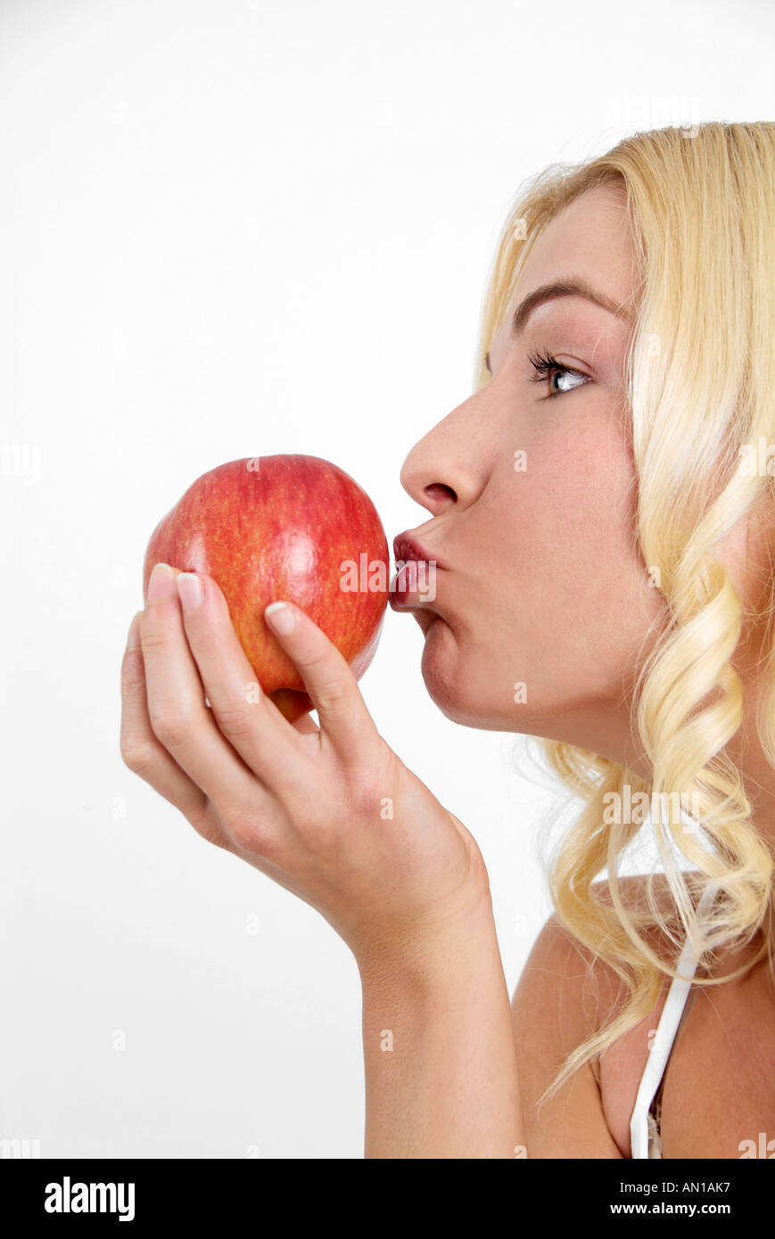 young woman enjoying a red delicious apple Stock Photo - Alamy