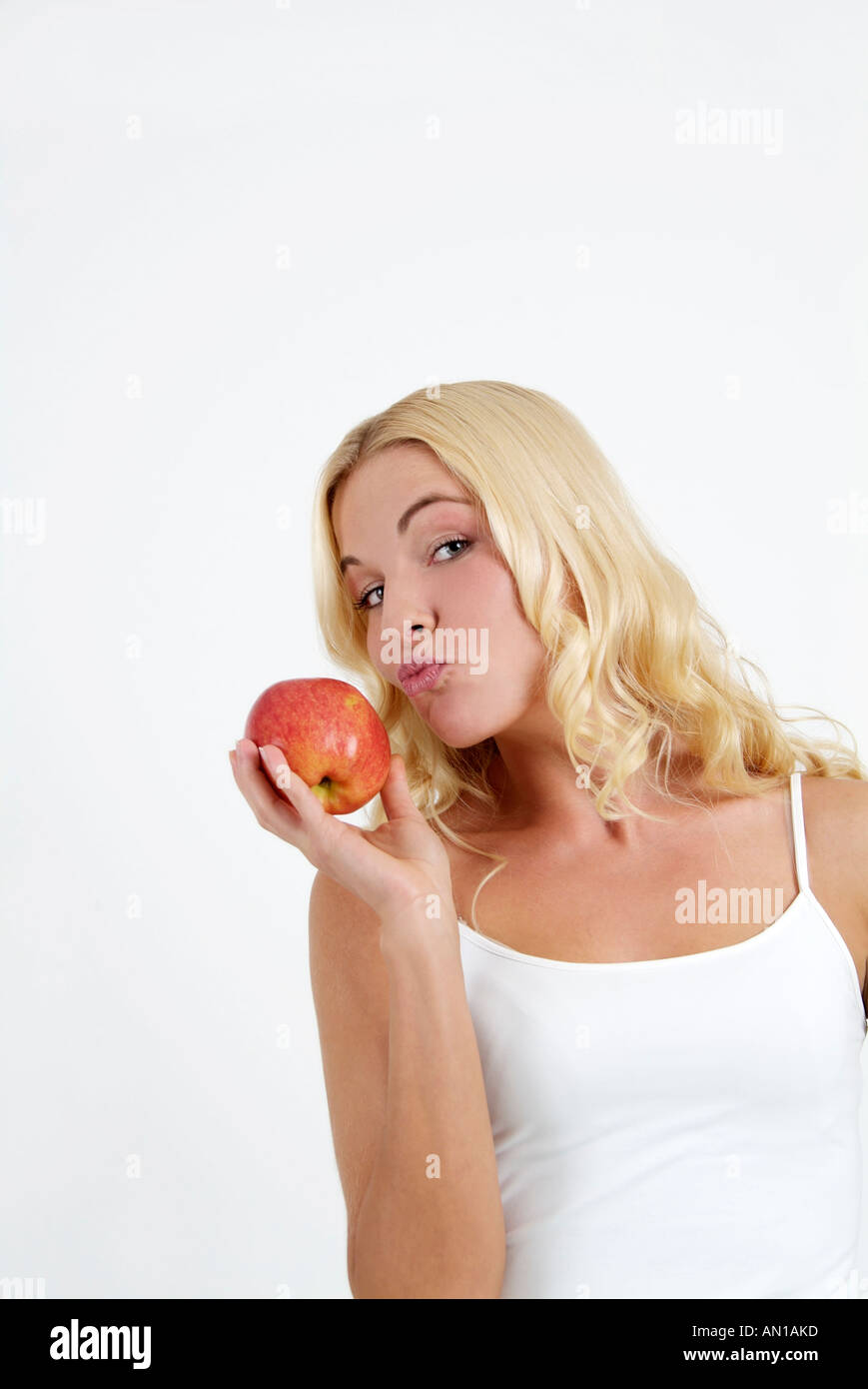 young woman enjoying a red delicious apple Stock Photo - Alamy