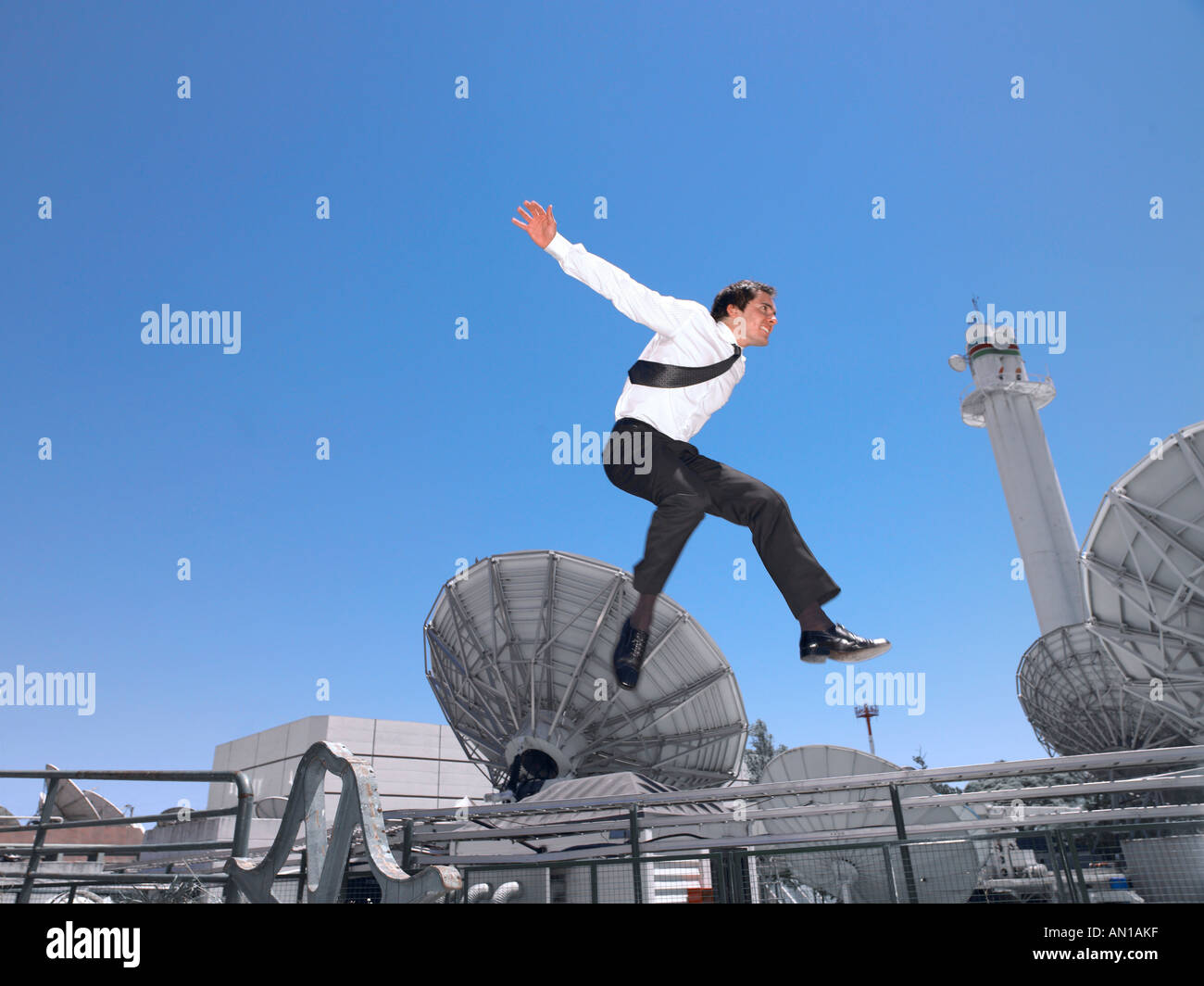 Man jumping over a rooftop Stock Photo - Alamy