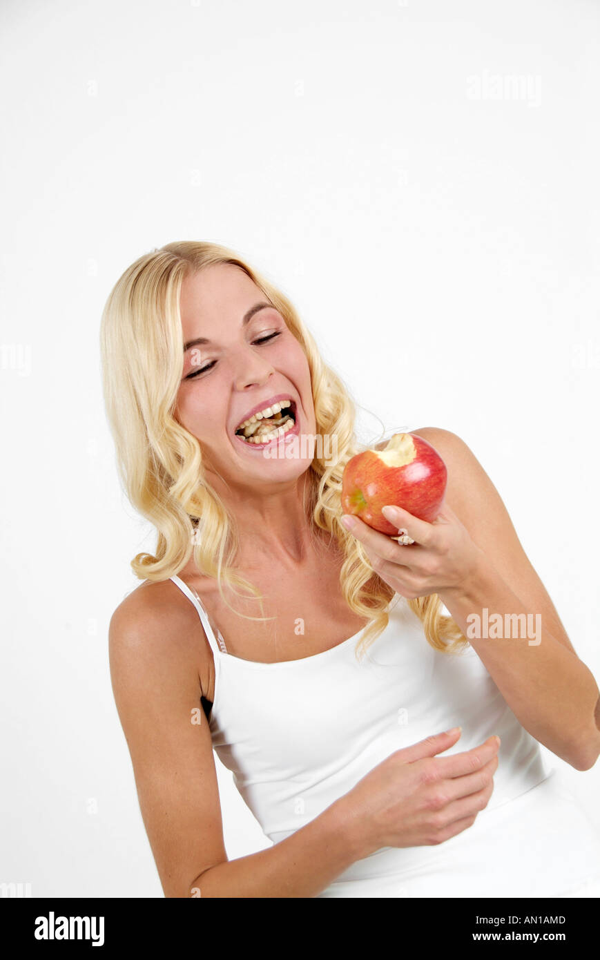 young woman enjoying a delicious apple Stock Photo - Alamy