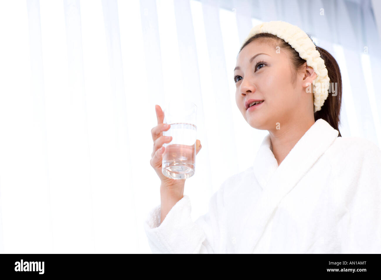 Japanese woman having a glass of water Stock Photo - Alamy
