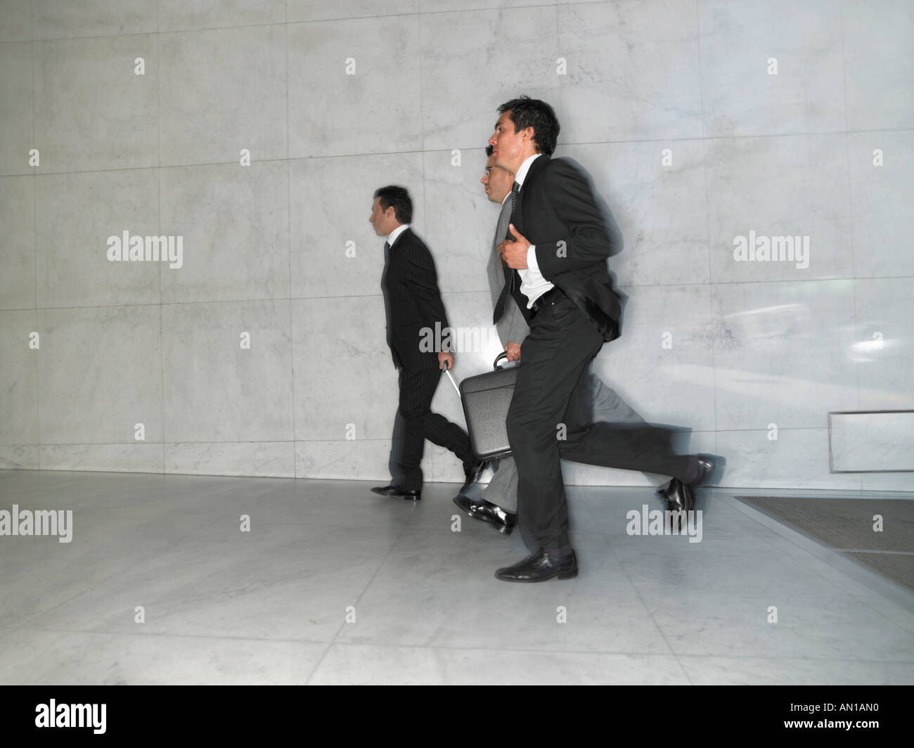 Three men running Stock Photo - Alamy