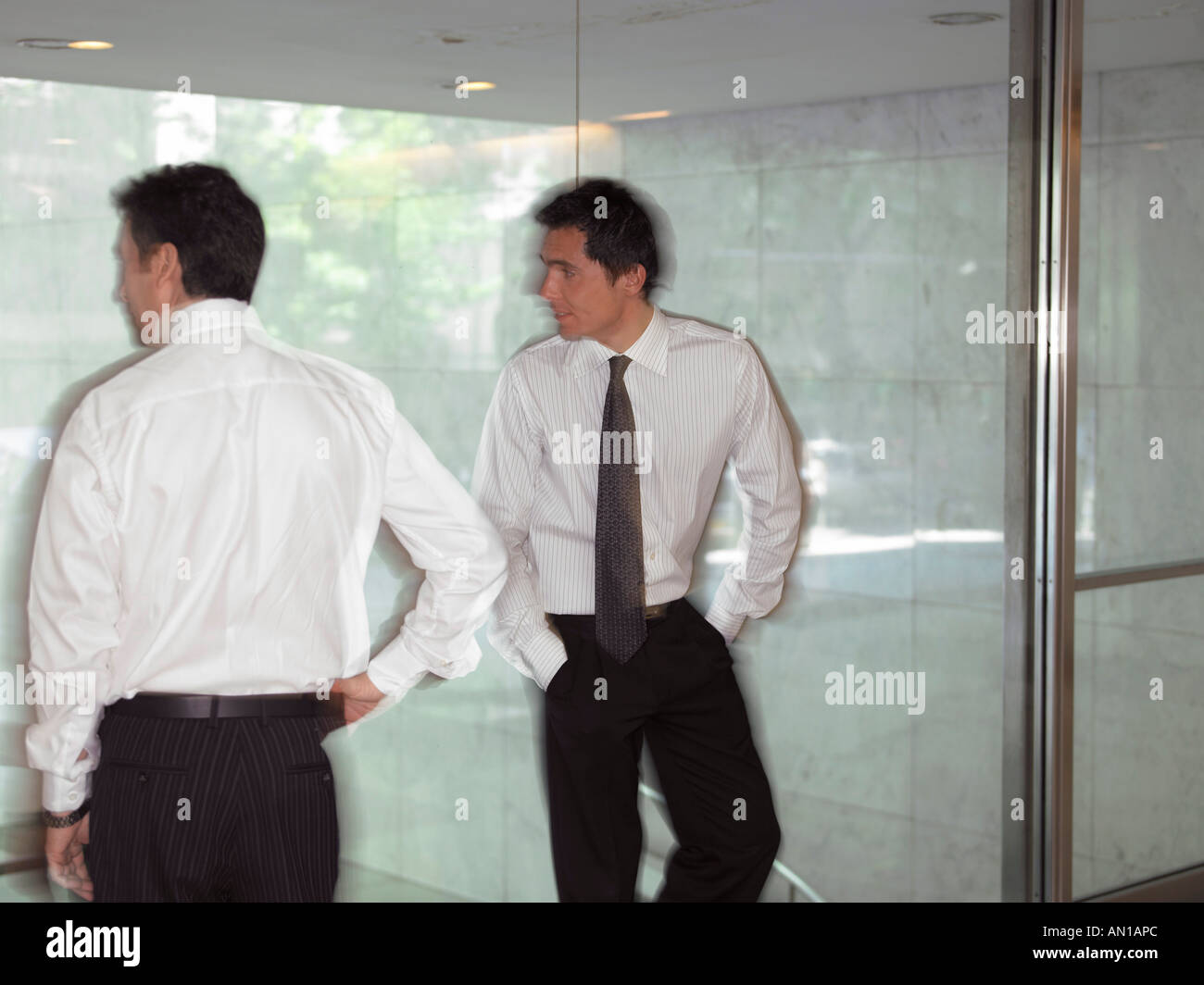 Two men looking through a glass window Stock Photo - Alamy