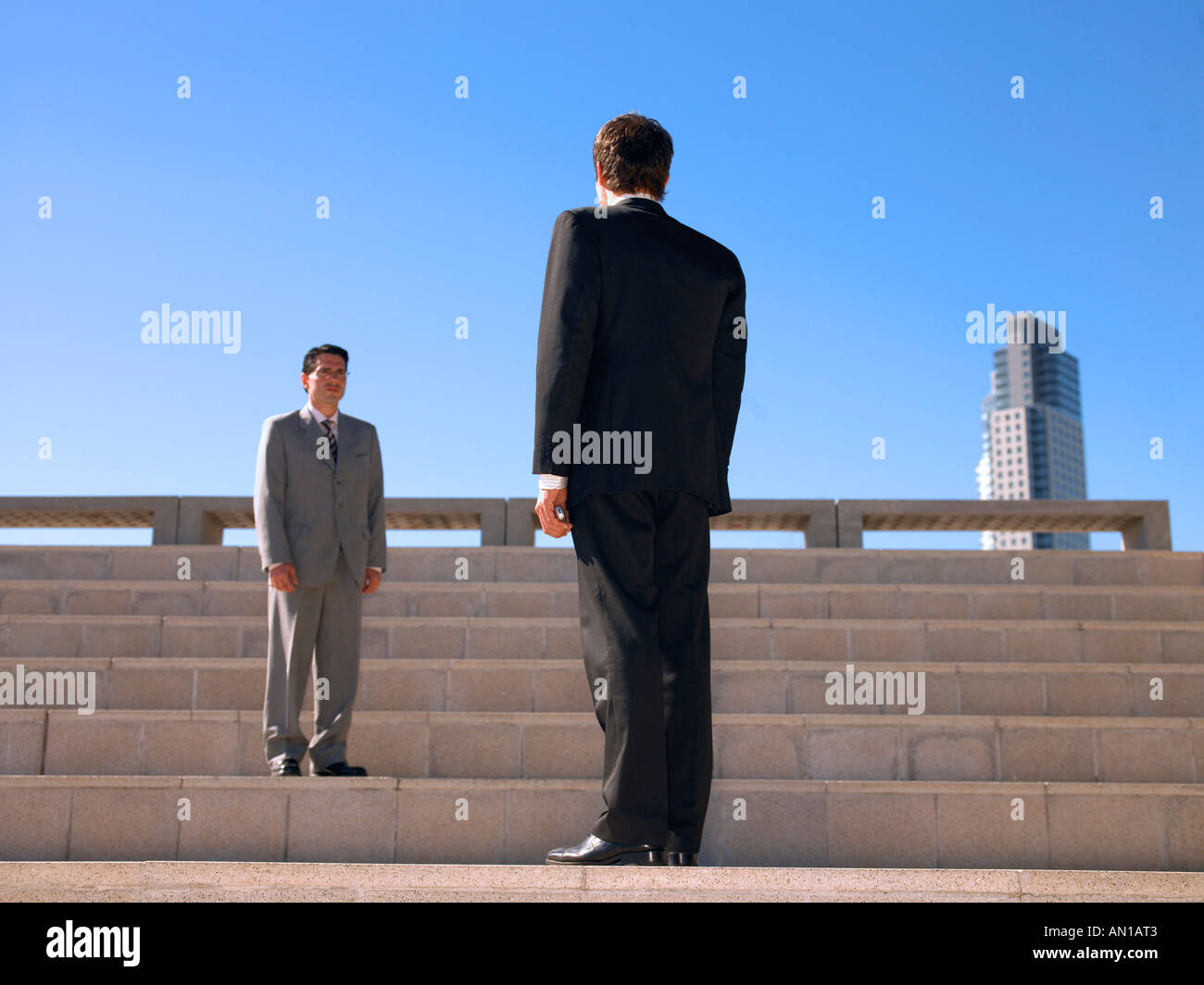 Two men facing each other on some steps Stock Photo - Alamy