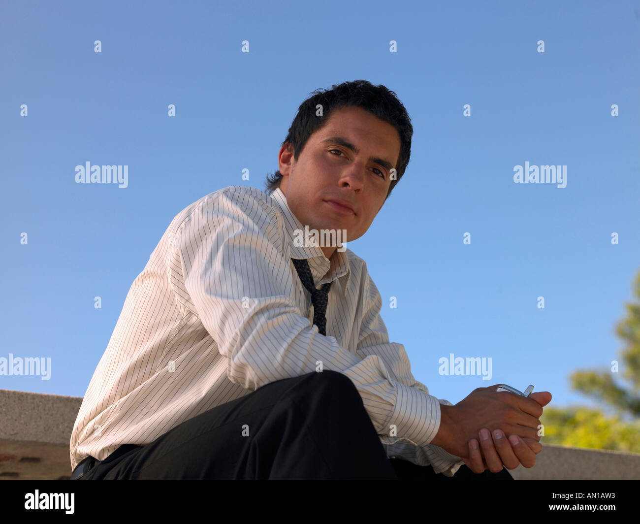 A man sitting looking directly at the camera Stock Photo - Alamy