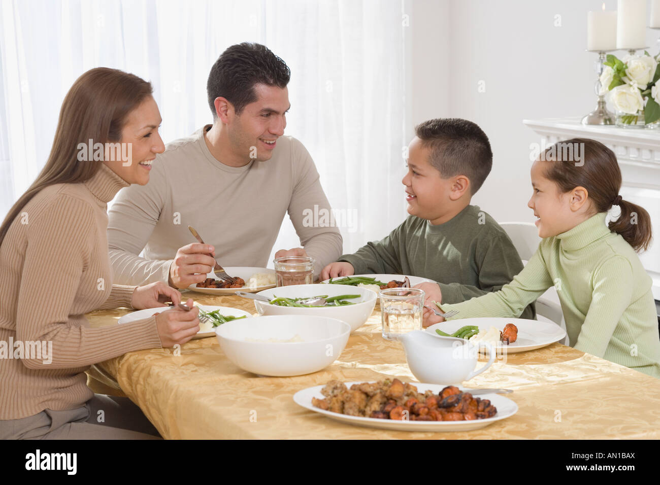 Hispanic family eating at dinner table Stock Photo - Alamy