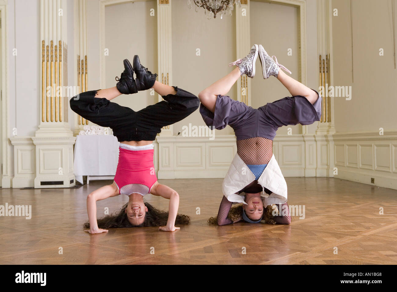 Two young women doing headstands Stock Photo - Alamy