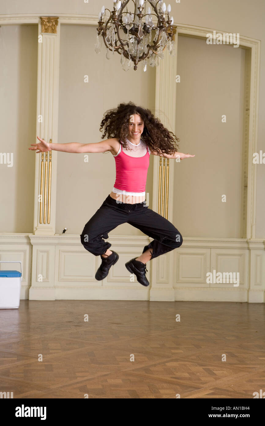 Young woman jumping in dance class Stock Photo - Alamy