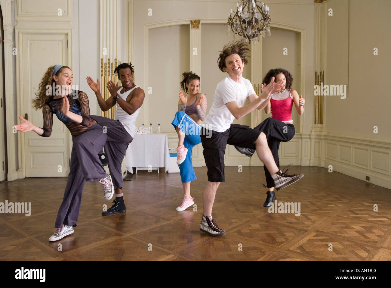 Group of dancers jumping and clapping Stock Photo - Alamy