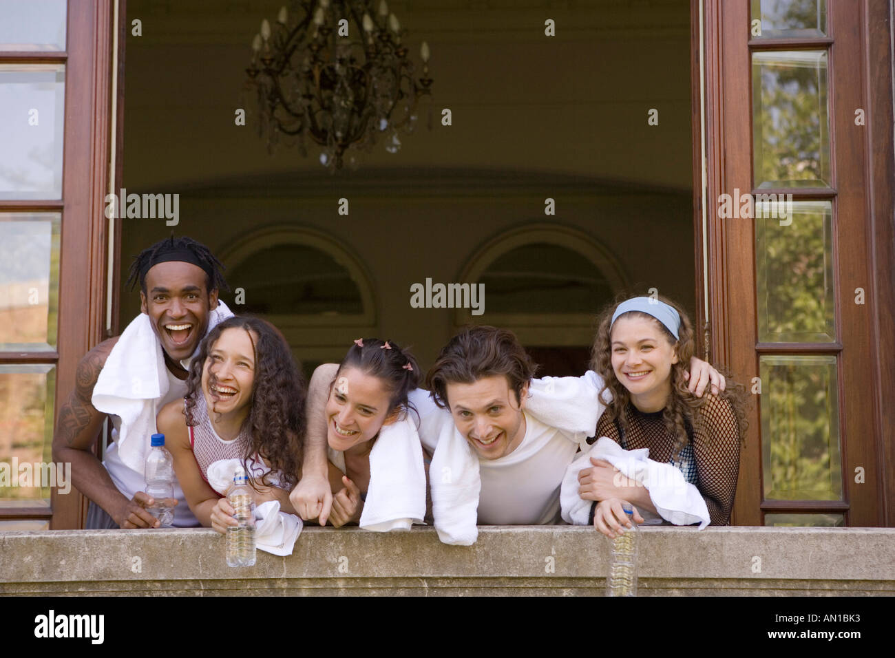Group of dancers huddled together on balcony Stock Photo - Alamy