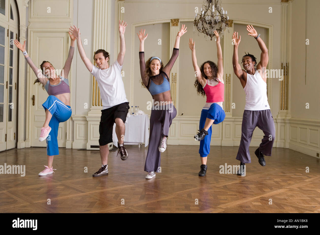 Group of young men and women dancing in a row Stock Photo - Alamy