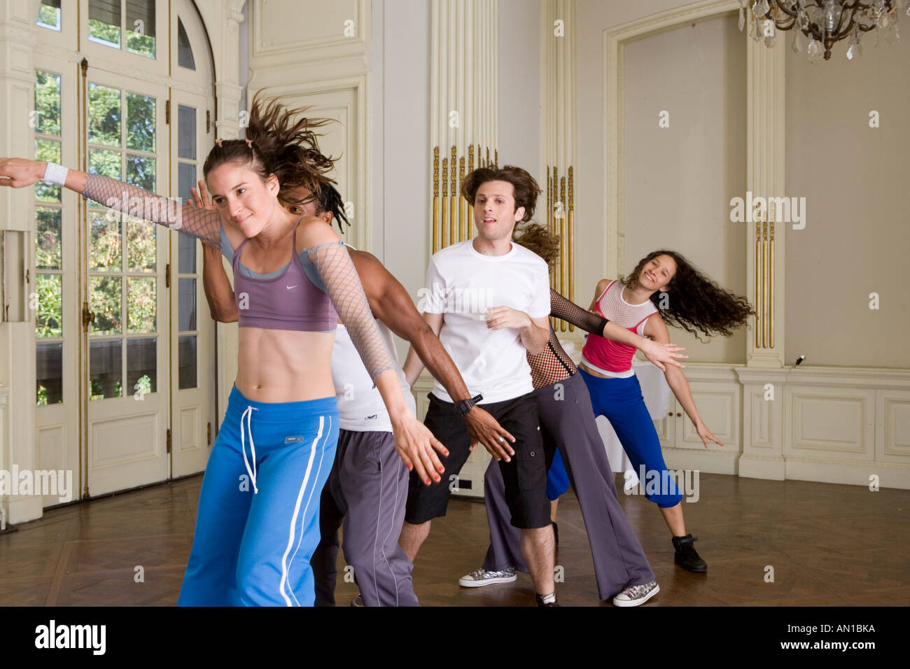 Group of young men and women dancing together Stock Photo - Alamy