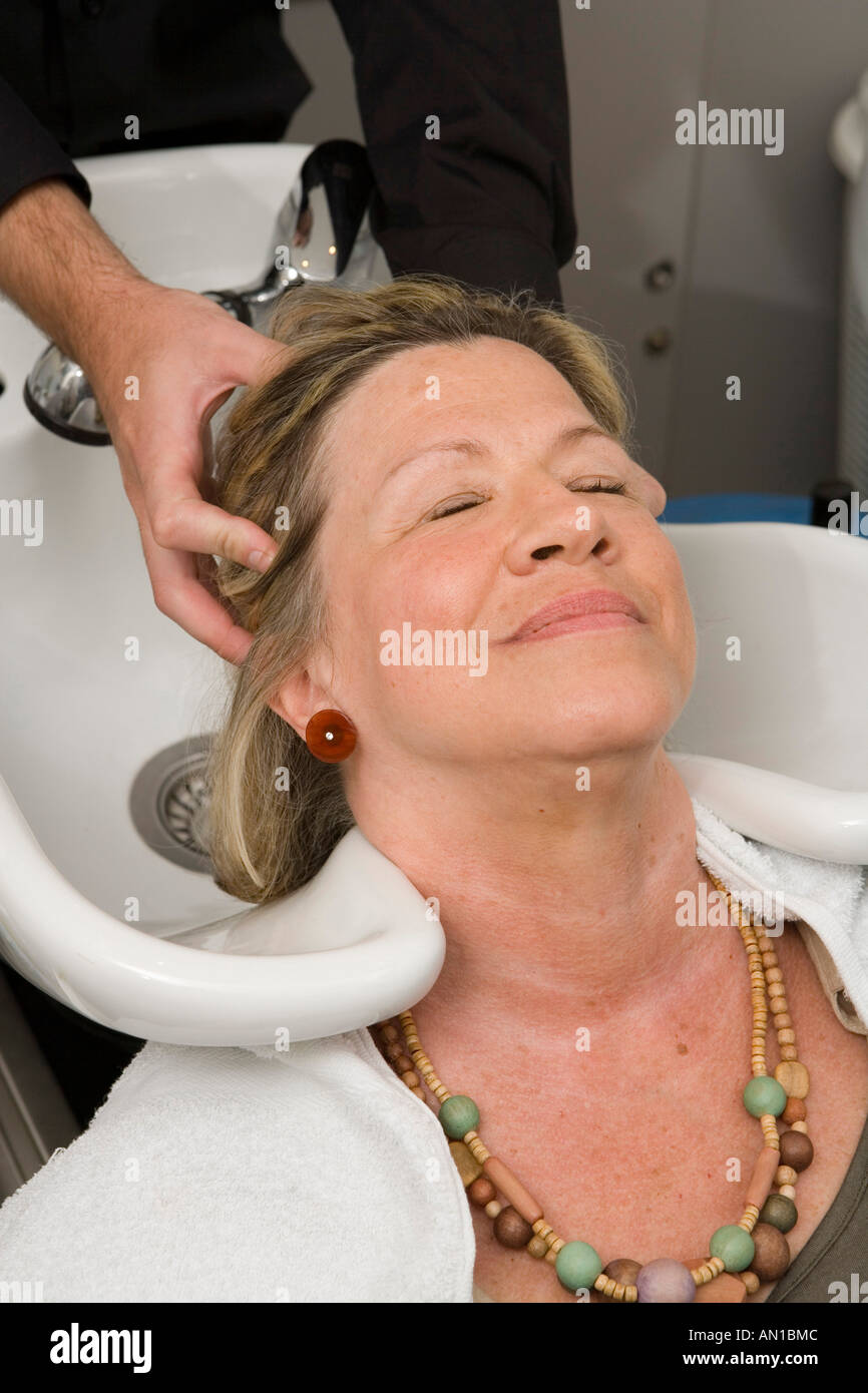Woman having her hair washed Stock Photo - Alamy