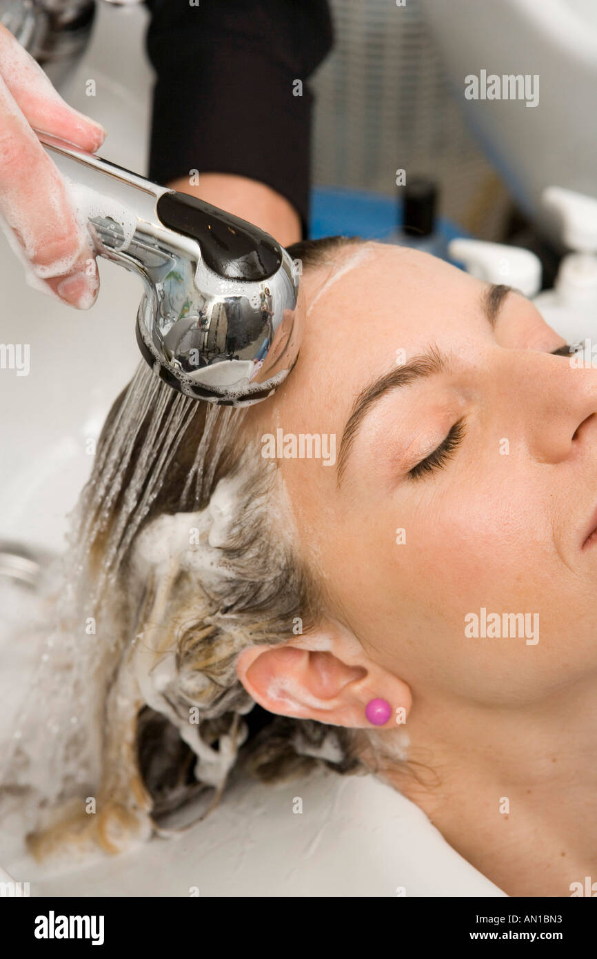 Woman s head being rinsed over a sink Stock Photo - Alamy