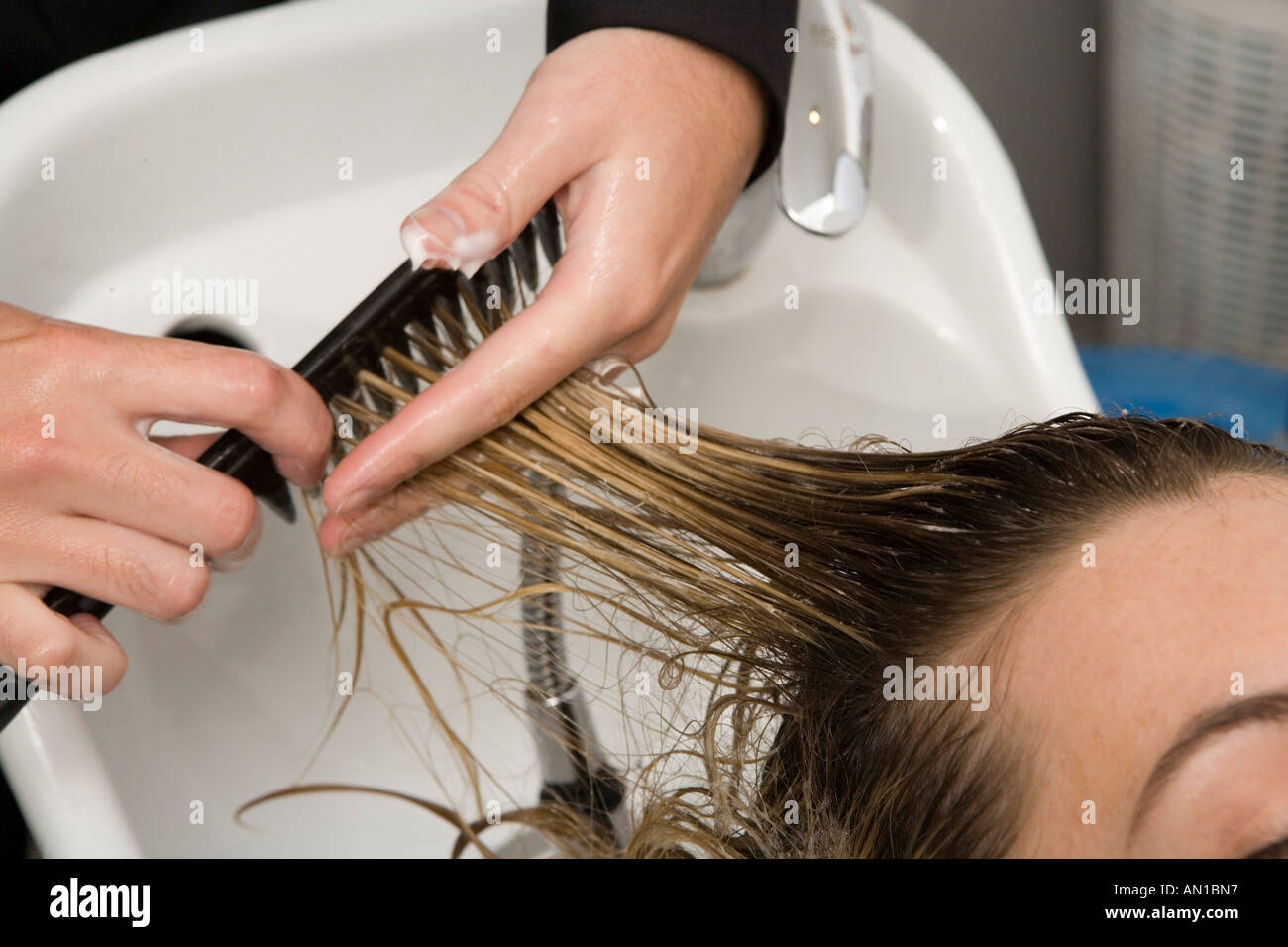 Hands combing through hair Stock Photo - Alamy