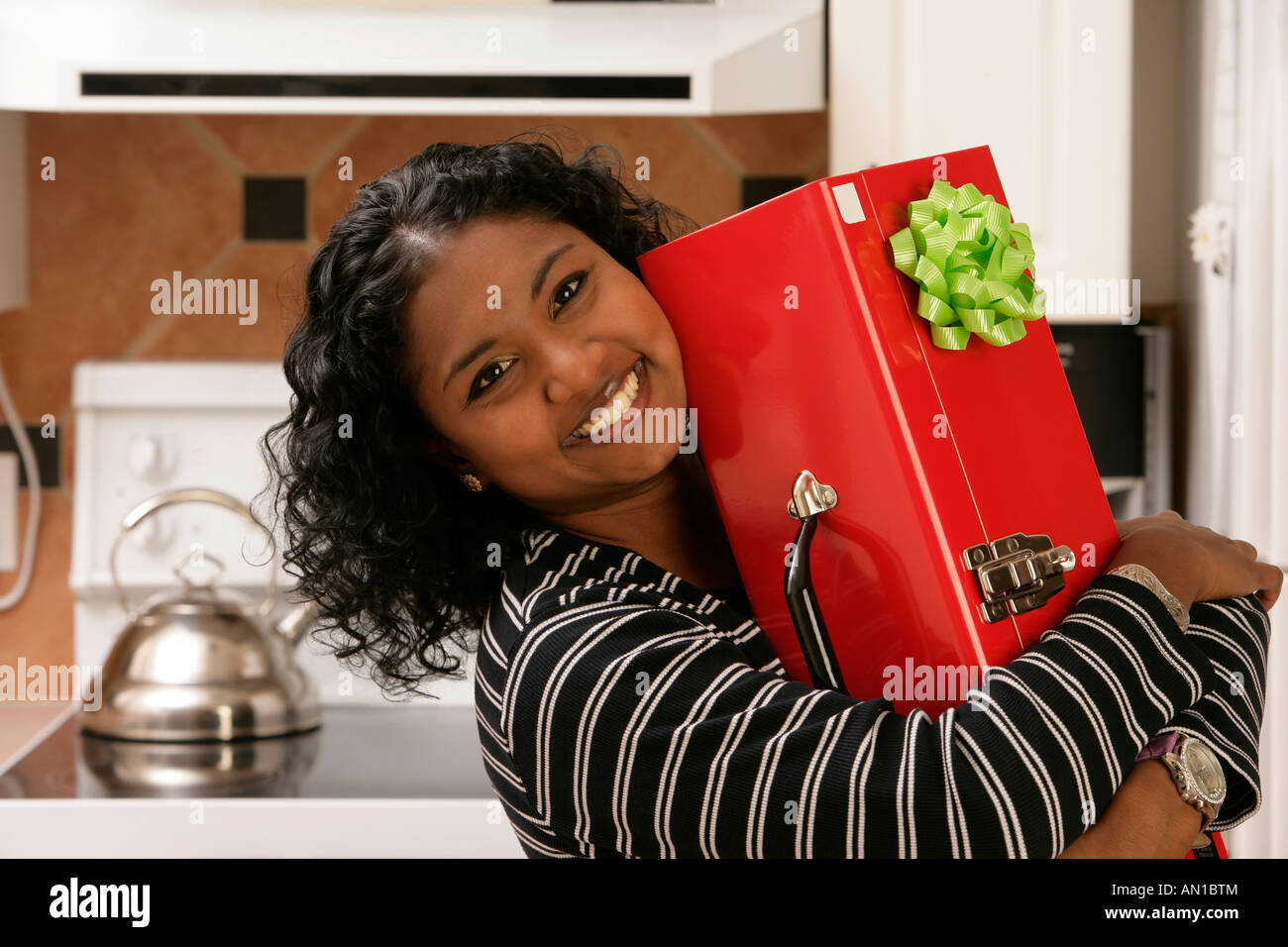 Woman carrying toolbox with bow Stock Photo - Alamy
