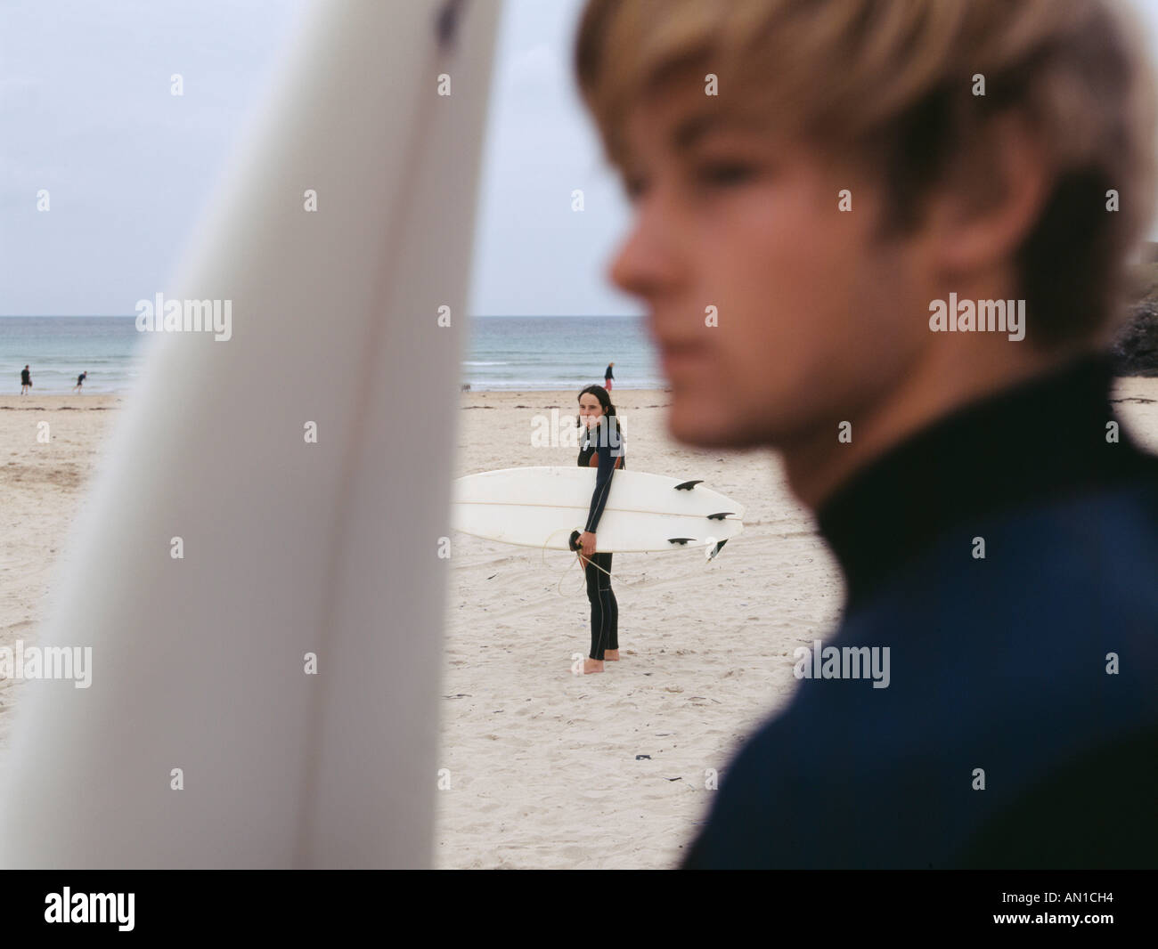 Two people holding surfboards Stock Photo - Alamy