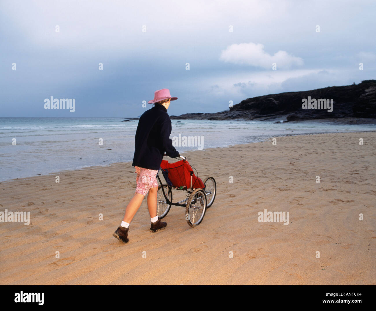 Person pushing a buggy Stock Photo - Alamy