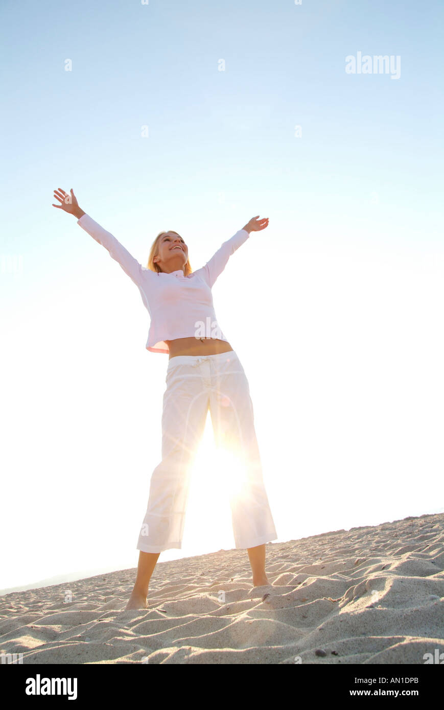 young woman 20+ relaxing at beach, sunset, backlight, free, easy, happy ...