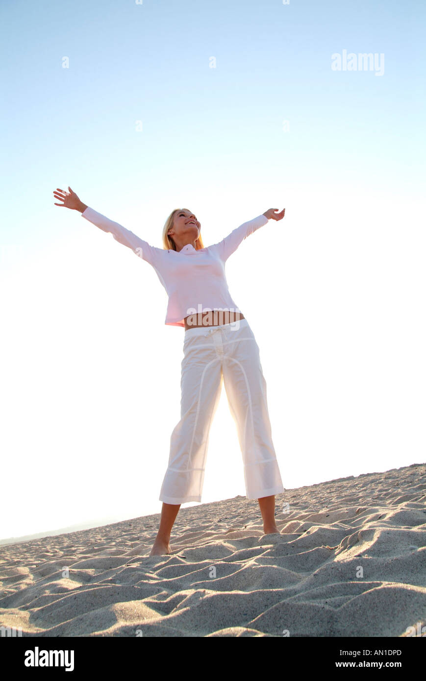 young woman relaxing at beach, sunset, backlight, free, easy, happy ...
