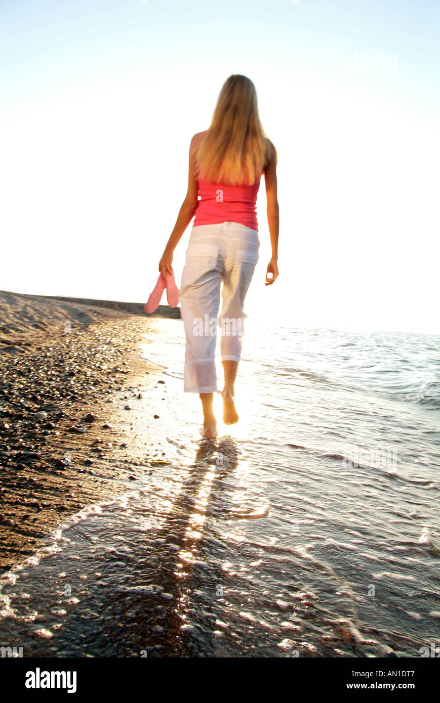 young woman relaxing at beach, sunset, backlight, chillout beach sunset ...
