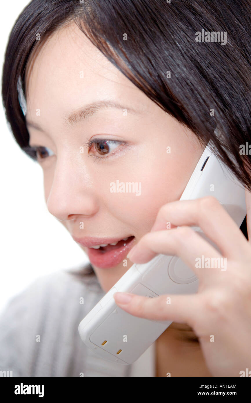 Japanese office lady talking with a cell phone Stock Photo - Alamy