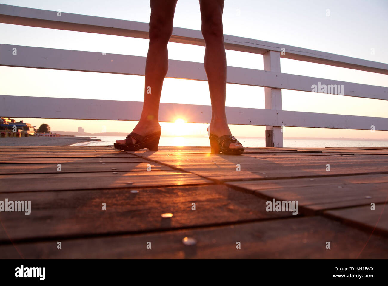young woman relaxing at beach, sunset, backlight, chillout Stock Photo ...