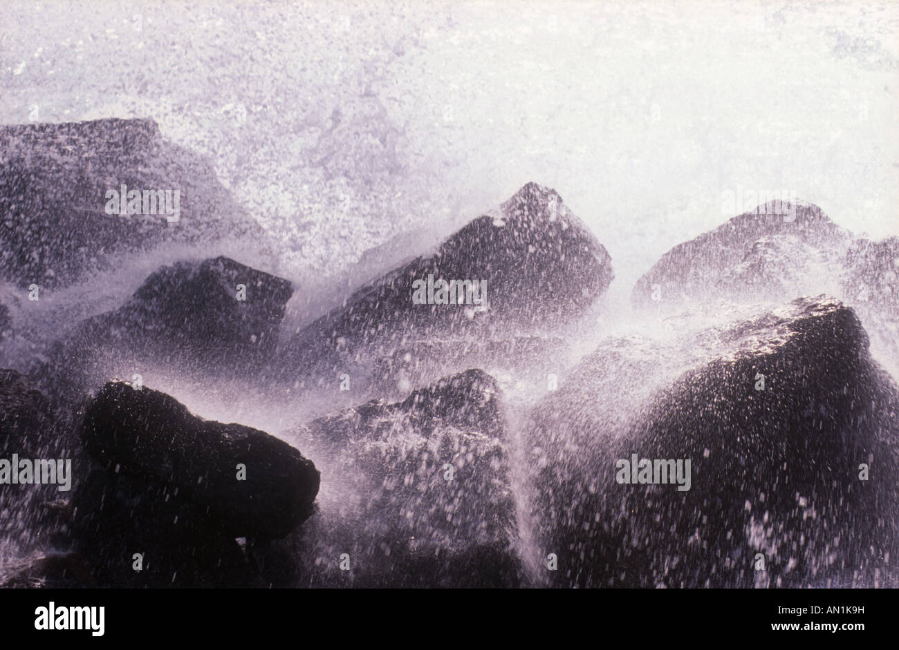 Water crashing onto rocks at seaside Stock Photo - Alamy
